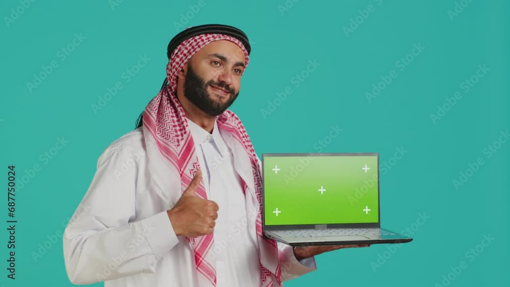 Islamic guy presents greenscreen on pc with smart isolated display for ...