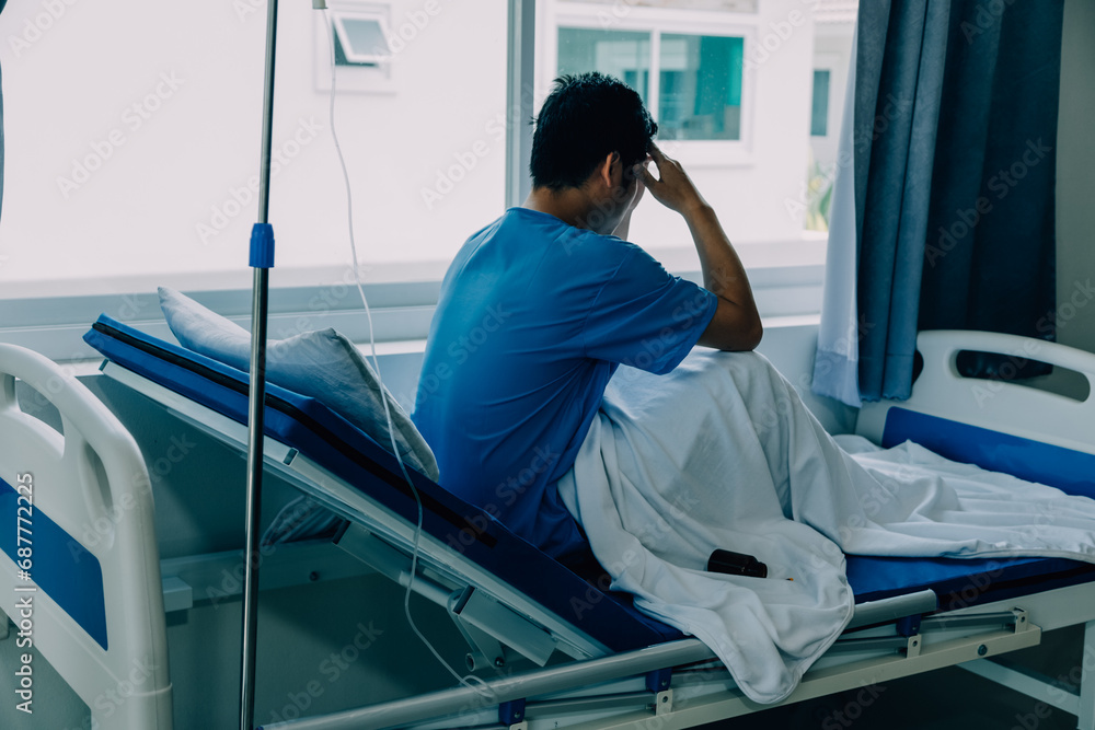 patient sat on the bed and looked out the window in the hospital alone ...