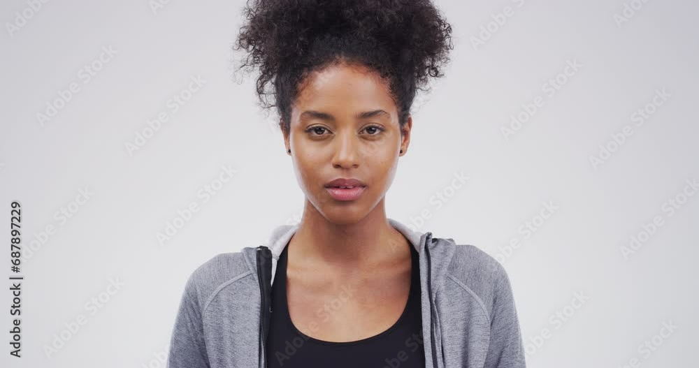 Serious black woman, blank stare and standing isolated against a studio ...