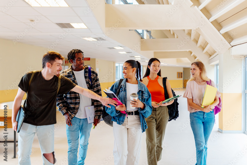 multiracial group of boys and girls classmates walking happily together ...