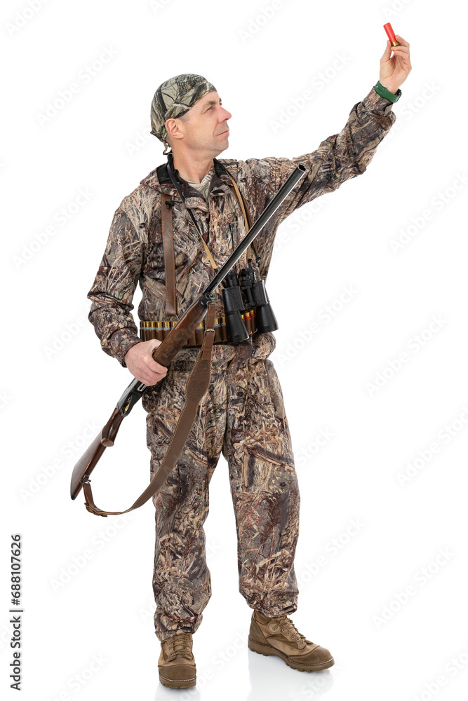 Full length portrait of duck hunter with a rifle in his hand and ...