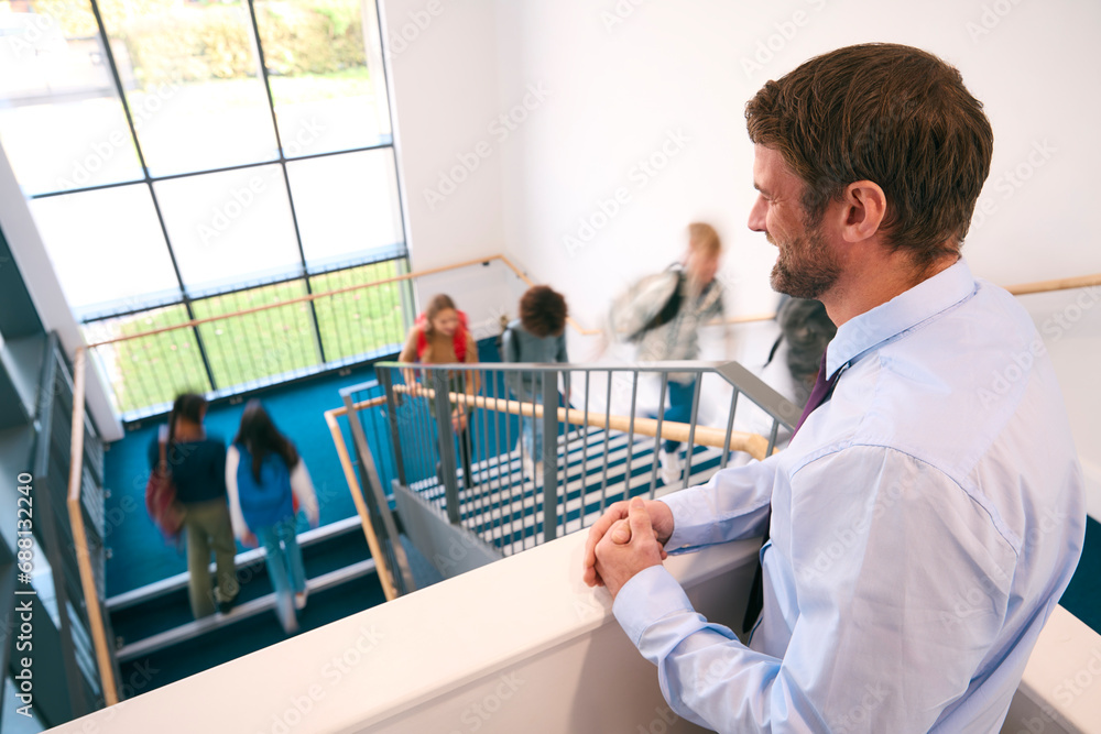 Teacher Looking Down On Group Of Secondary Or High School Pupils Inside ...