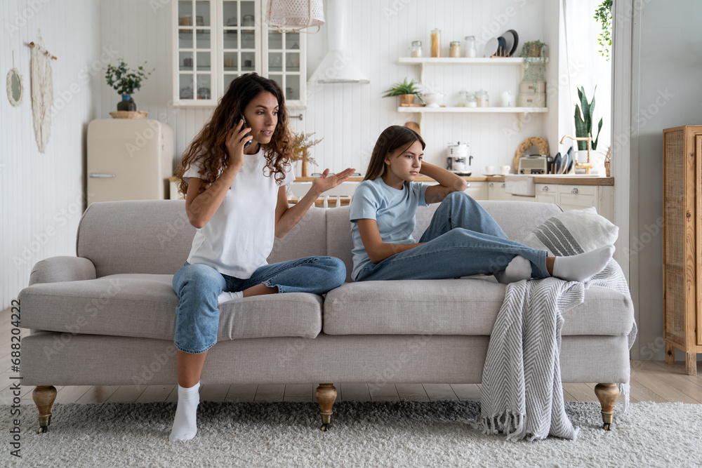 Emotional anxious mother arguing, swearing by phone in front of child ...