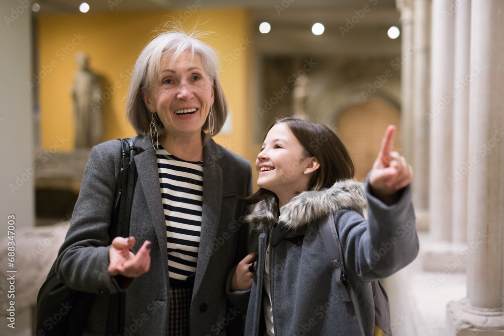 Photo & Art Print Friendly elderly female tutor showing interested ...