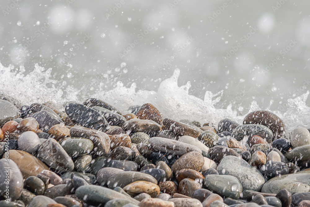 Pebble gravel stones sea water splash defocused bokeh lights nature ...