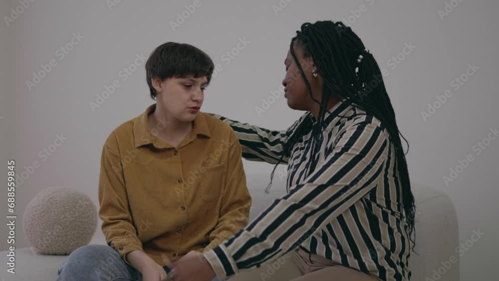 Loving caring beautiful black female talking to upset depressed young ...