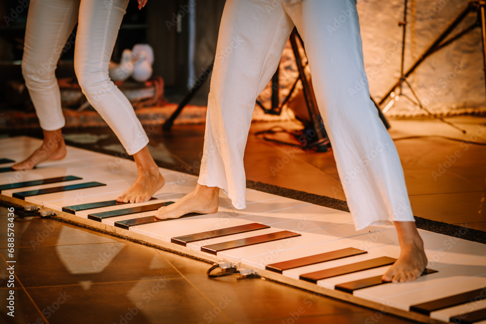 The Famous Big Pian. Popular Grand Floor Keyboard. People playing close ...