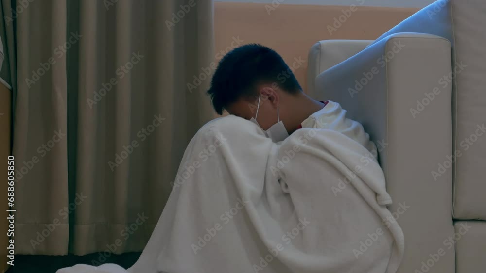 Stockvideon Asian kid boy face wearing a mask was sick sitting in the ...