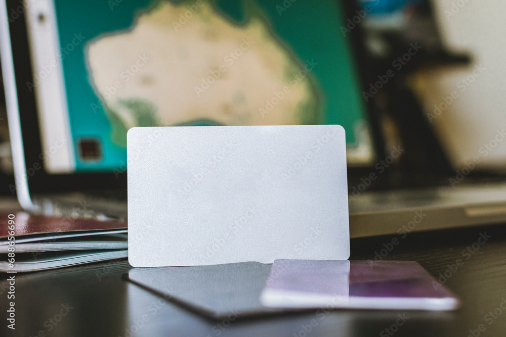 image of a card and in the background a laptop with its screen on a map ...