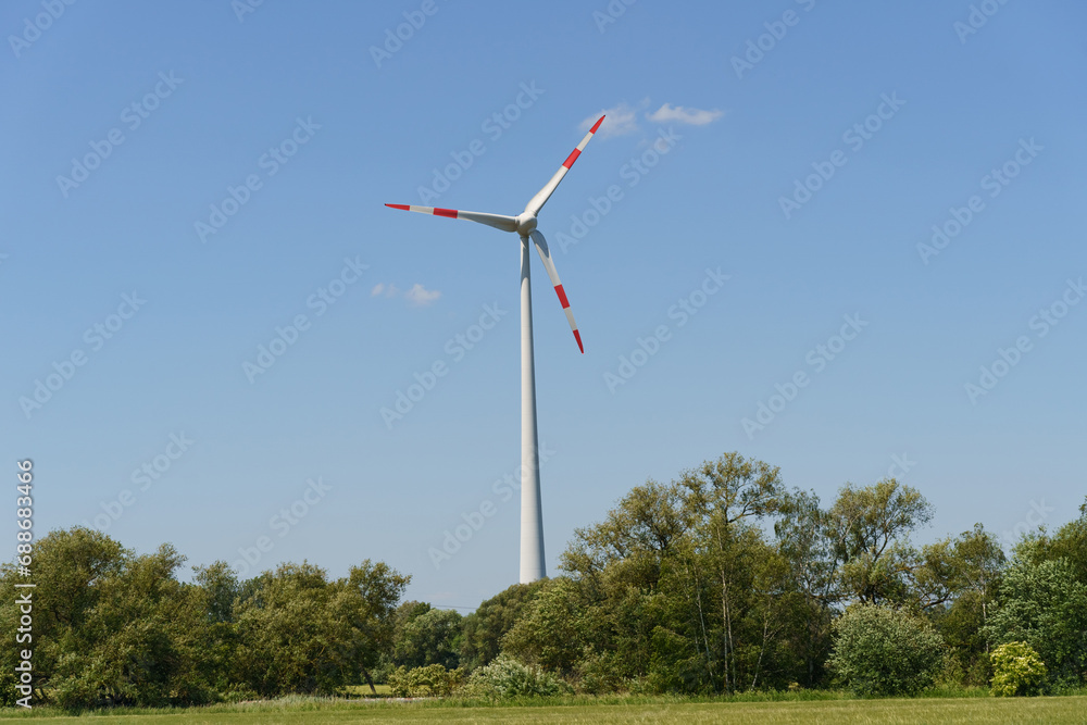 Landscape from renewable energy wind turbine with field, forest and sky ...