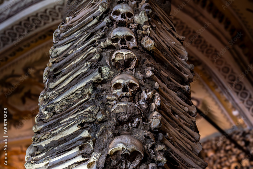 Column of human skulls with bones on the sides creating a macabre ...