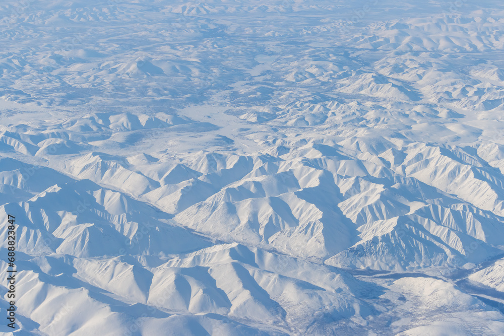 Aerial view of snow-capped mountains. Winter snowy mountain landscape ...
