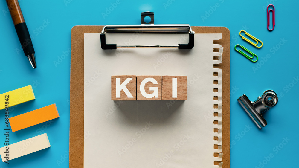 There is wood cube with the word KGI. It is an abbreviation for Key ...