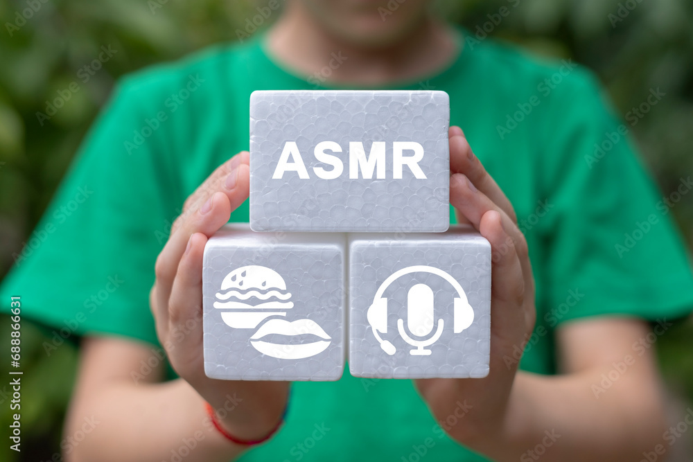 Little girl holding white plastic foam blocks with abbreviation: ASMR ...