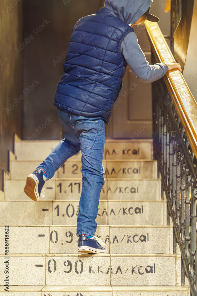 Boy wearing jeans and vest goes upstairs with burnt calories marks on ...