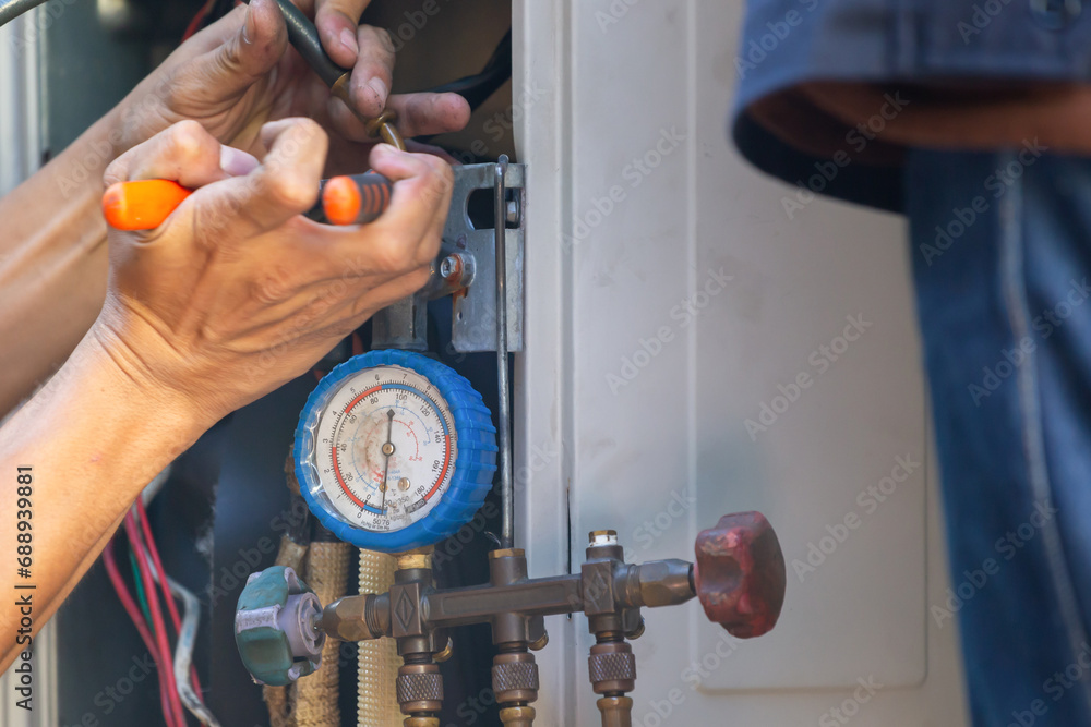 Air Conditioning Repair man checking and fixing modern air conditioning ...