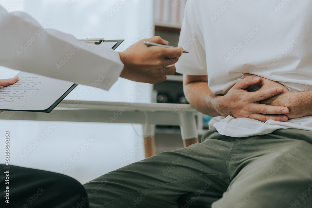 Crohn's disease or ulcerative colitis concept. Doctor counseling male ...