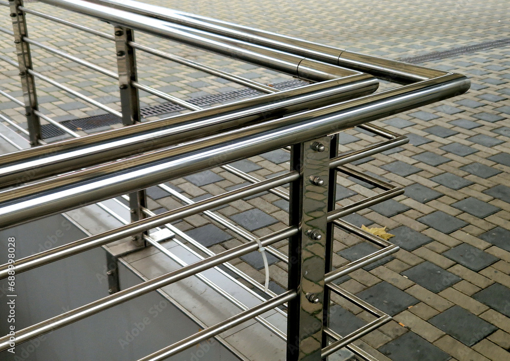staircase and wide pedestrian bridge with perforated metal floor ...