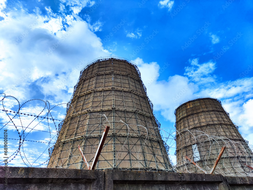 Big tower of CHPP close-up. White steam from wide pipe of CHP on blue ...