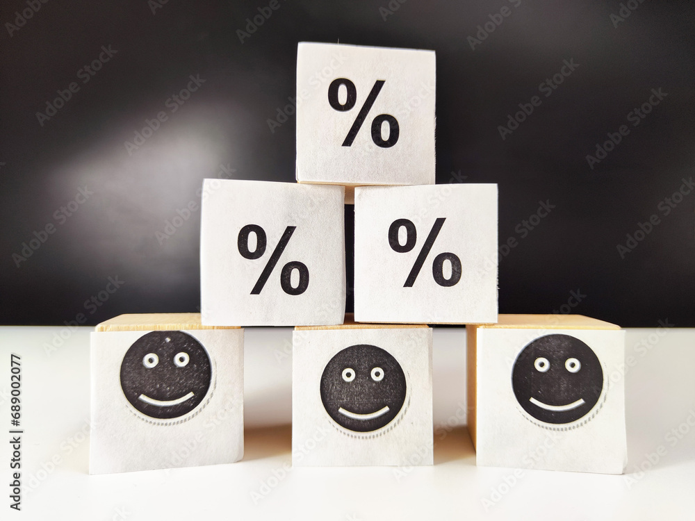 Wooden cubes in a column and a row with white signs with a smiley sign ...