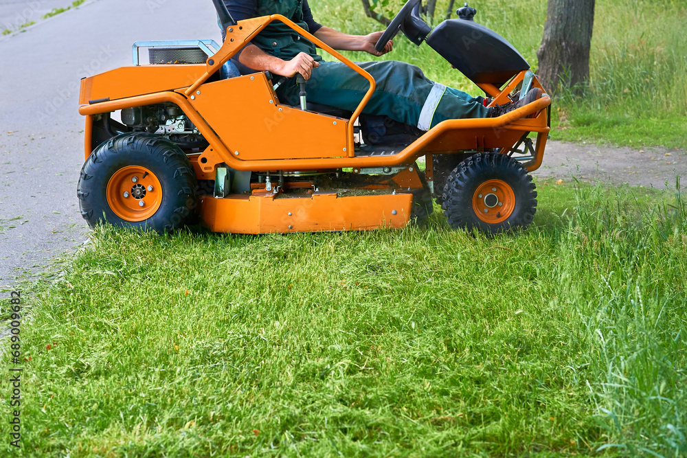 Professional grass cutting on lawns with a mini tractor lawn mower ...