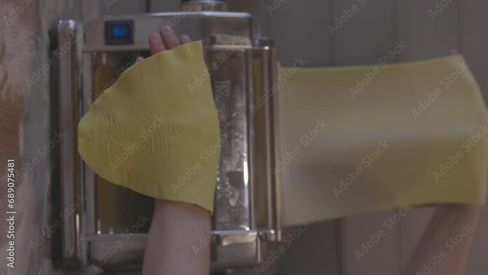 Italian pasta being made on the machine for dough rolling. Fresh ...