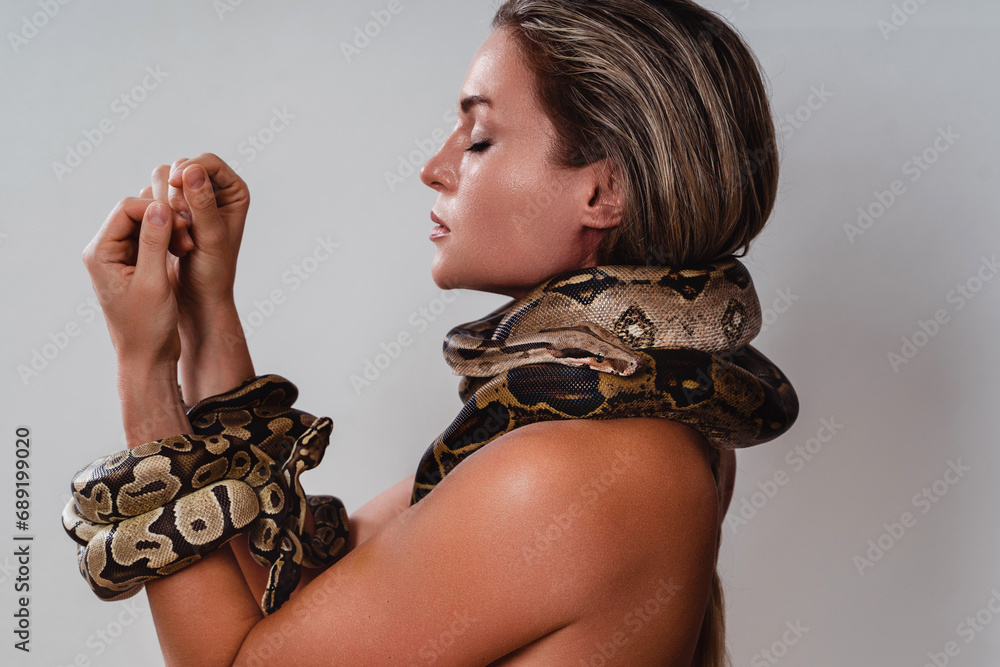 Beautiful woman with python snakes elegantly slithering over her neck and wrists Stock Photo ...