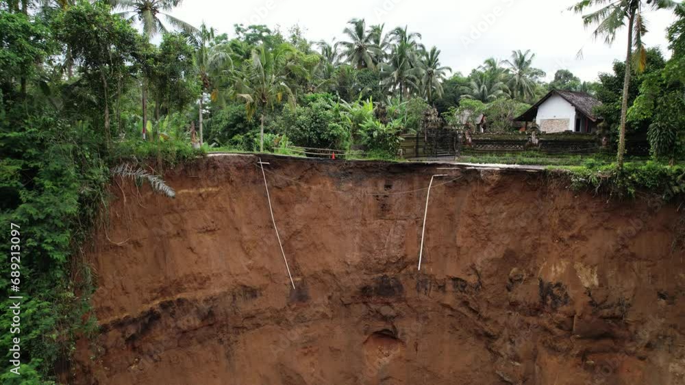 Collapsed road, camera look to brink at top of slope. Aerial shot of ...
