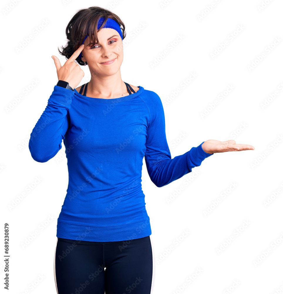 Beautiful young woman with short hair wearing training workout clothes ...