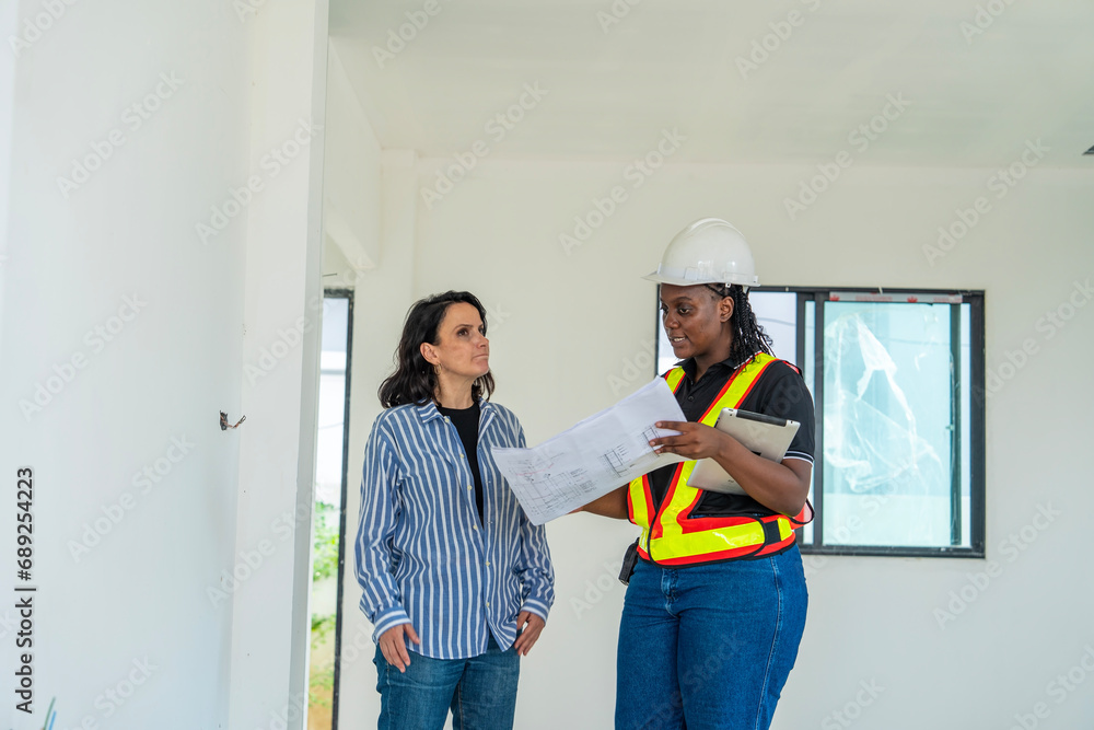 Female customer renovating house walks and talks, inspects house, consults with engineer ...