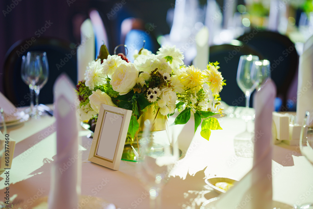 table with sign for number or names of guests in banquet hall of ...