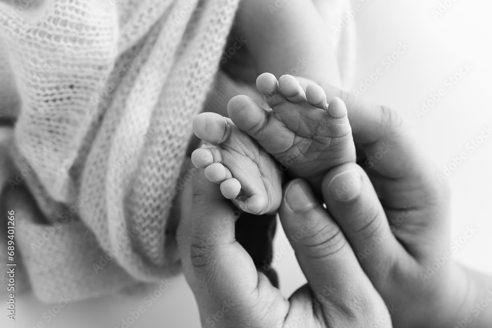 Children's foot in the hands of mother, father, parents. Feet of a tiny ... Children's foot in the hands of mother, father, parents. Feet of a tiny ...