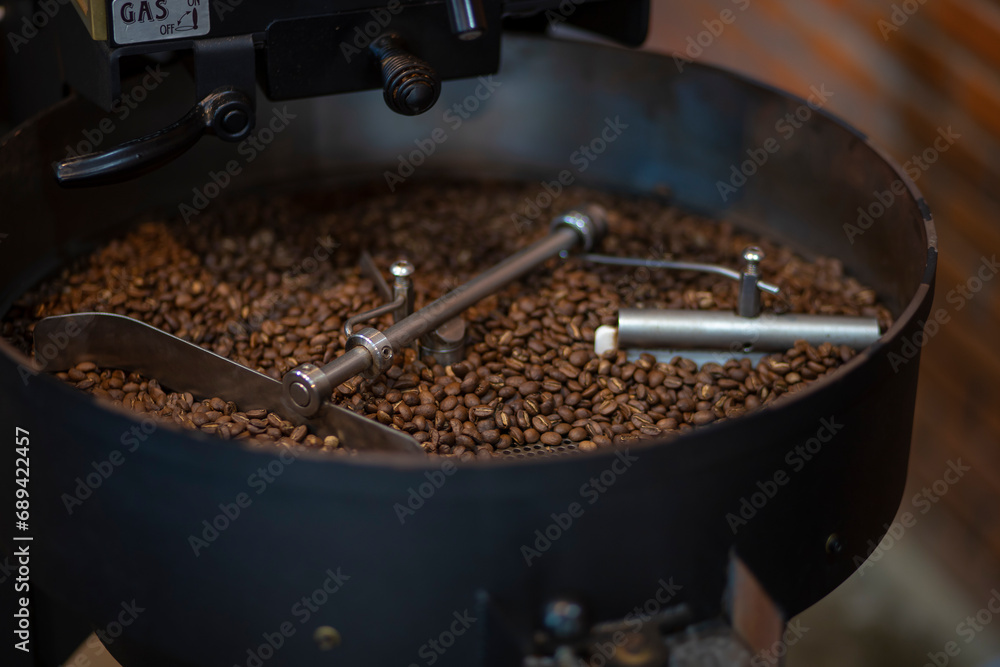 Coffee beans during the roasting process, moving paddle of the ...