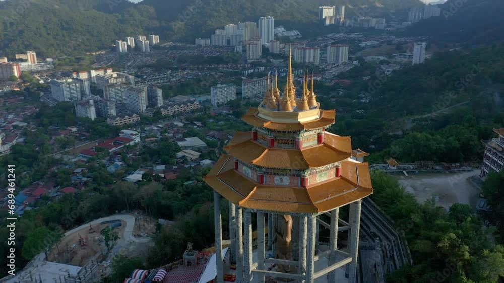 Circling shot around the side of the large bronze statue within the ...