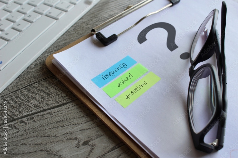 Close image of paper clipboard with question mark and text FREQUENTLY ...