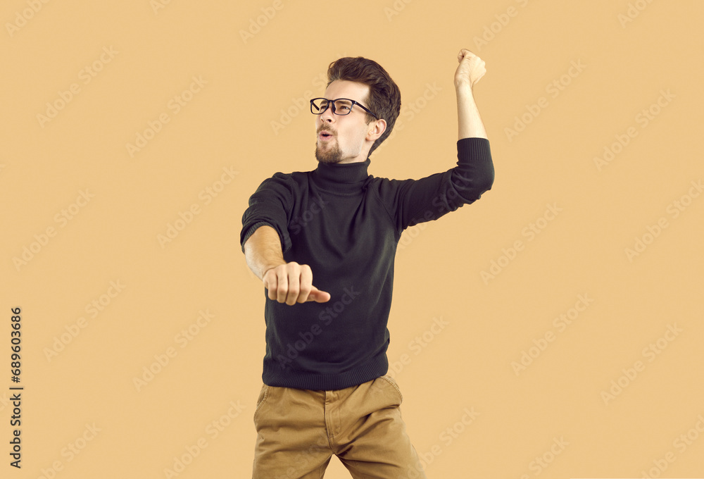 Handsome young man dancing Gangnam style over studio background ...
