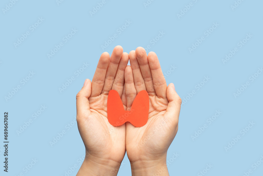 World Thyroid Day concept. Human hand holding thyroid gland shape made ...