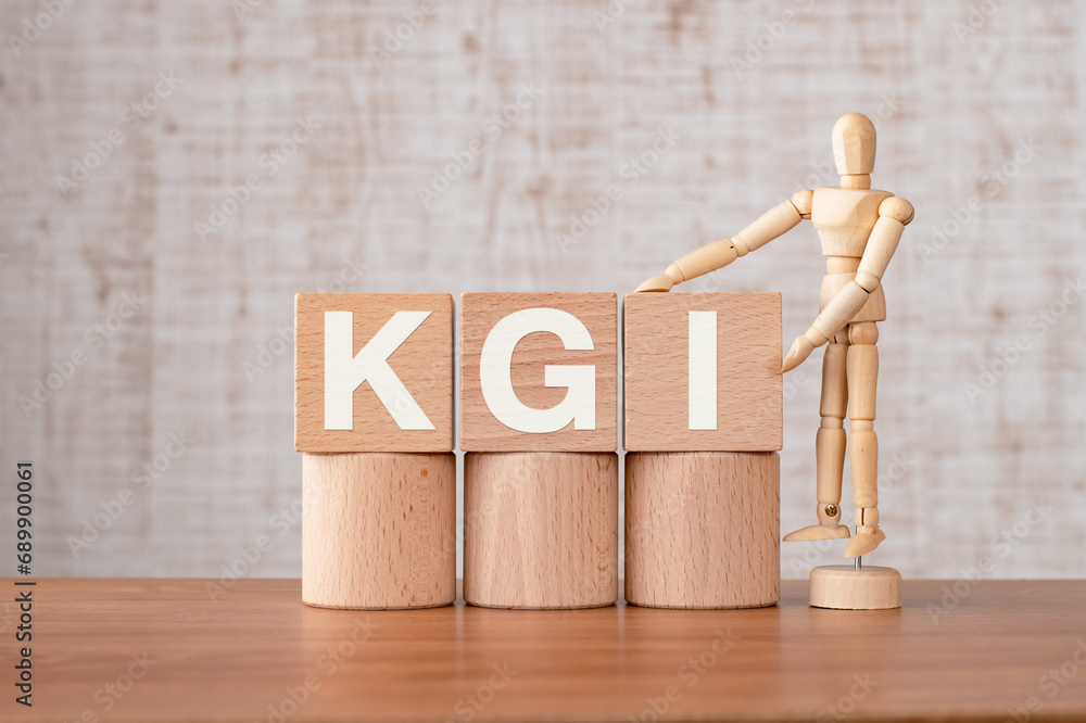 There is wood cube with the word KGI. It is an abbreviation for Key ...