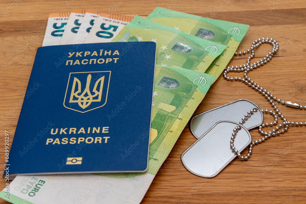 Soldier's medallion and Ukrainian passport, paper euro banknotes ...