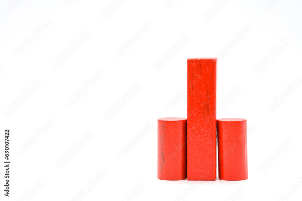Red wooden building block standing with cylinders on the left and right ...