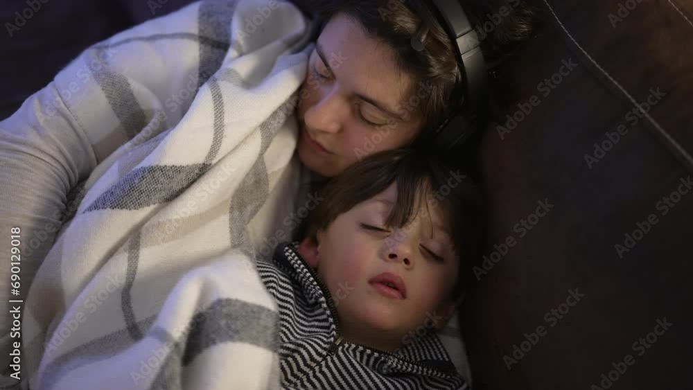 Parent and child napping together on couch. Sleeping little boy next to ...