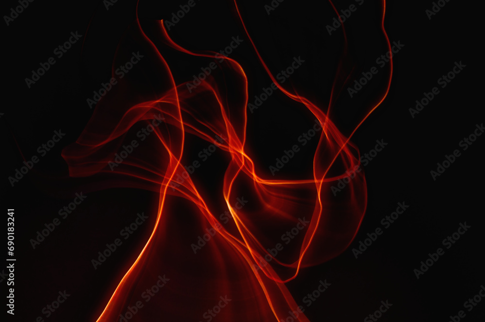 Fiery dance of red lines on a black background, images emerge from the ...