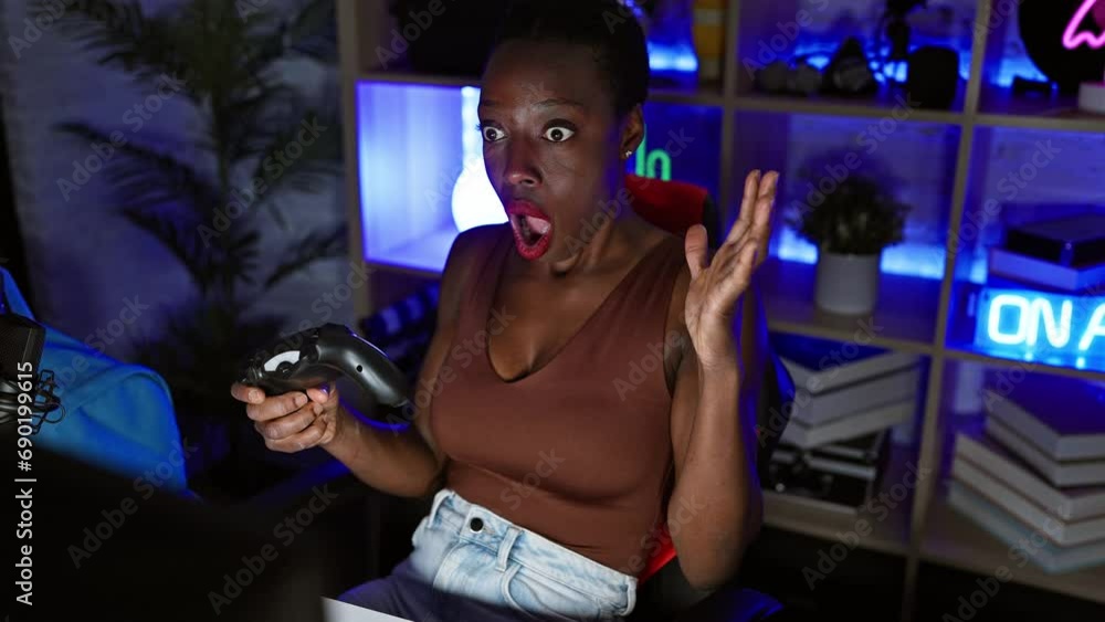 Astonished african american woman gamer, open-mouthed in shock and ...