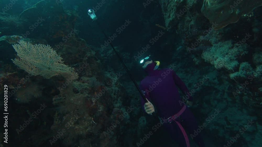 Freediver explores the coral reef in Raja Ampat, Indonesia and dives ...