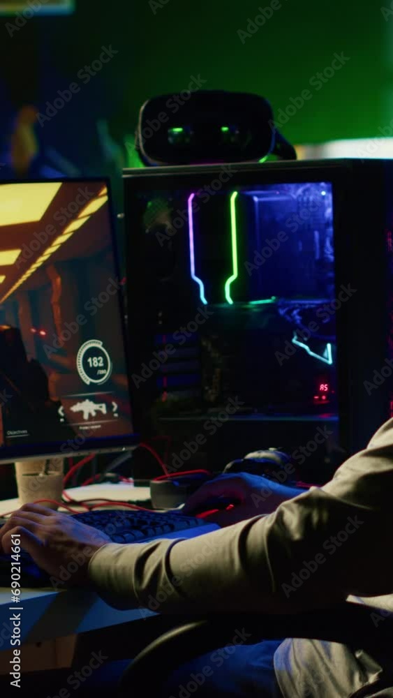 Vertical video Man playing first person shooter videogame with ...