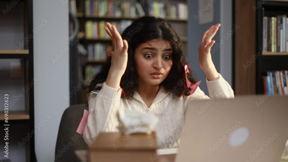 Nervous stressed young woman student typing quickly on laptop computer ...