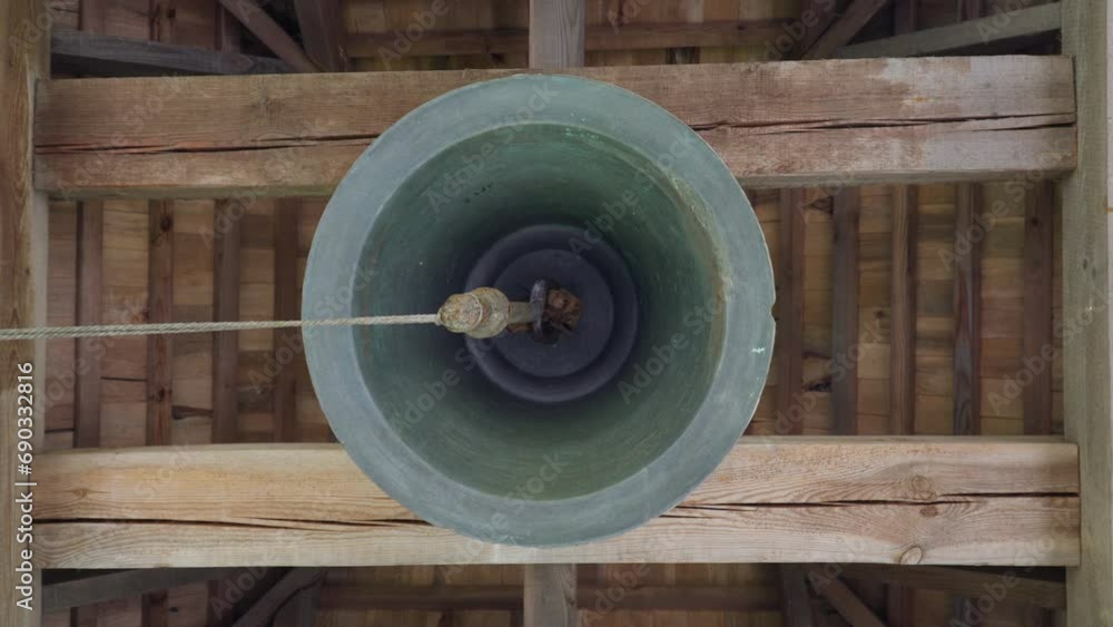 Video „Up view of old bell with rusty clapper and rope under wooden ...