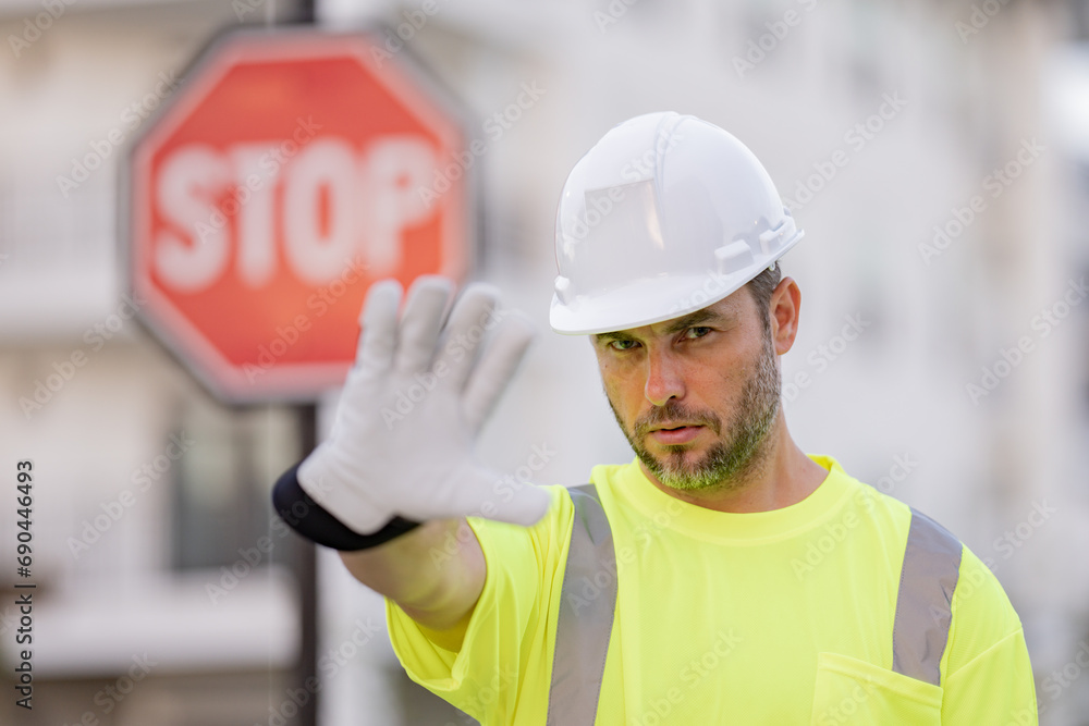 Builder with stop road sign. Builder with stop gesture, no hand ...