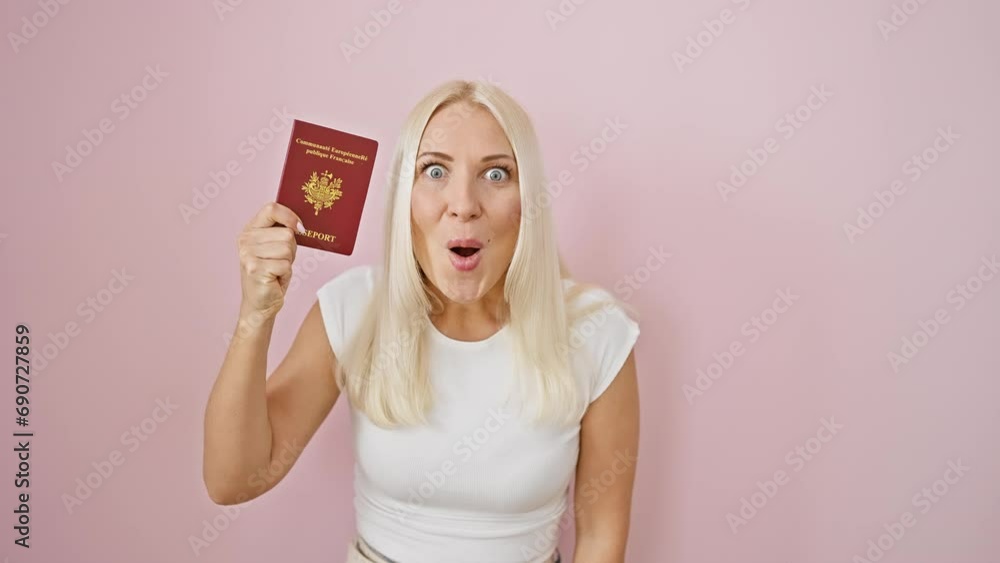 Shocked young blonde woman, mouth agape in disbelief, clutches france ...