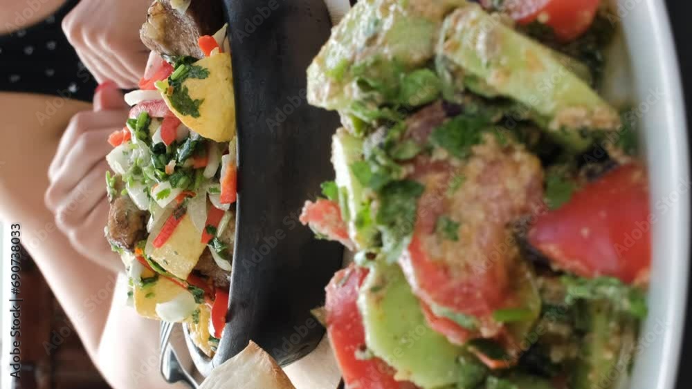 Vertical video. Close-up of female eating Ojahuri and drinking grape ...